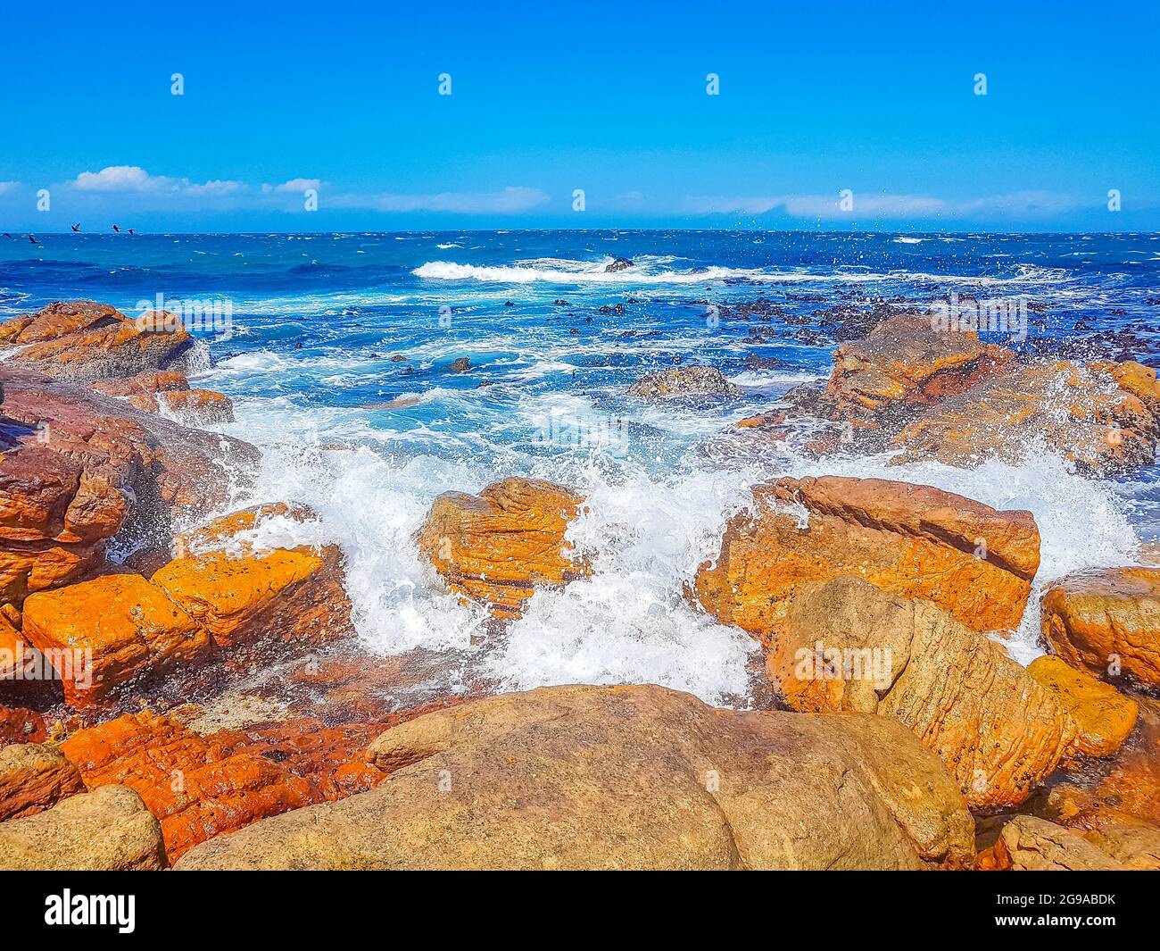 False Bay rough coast landscape with boulders waves and mountains with ...