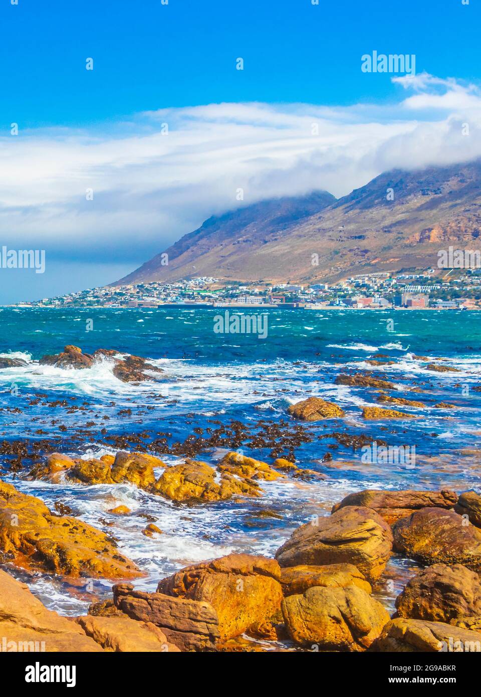 False Bay rough coast landscape with boulders waves and mountains with ...