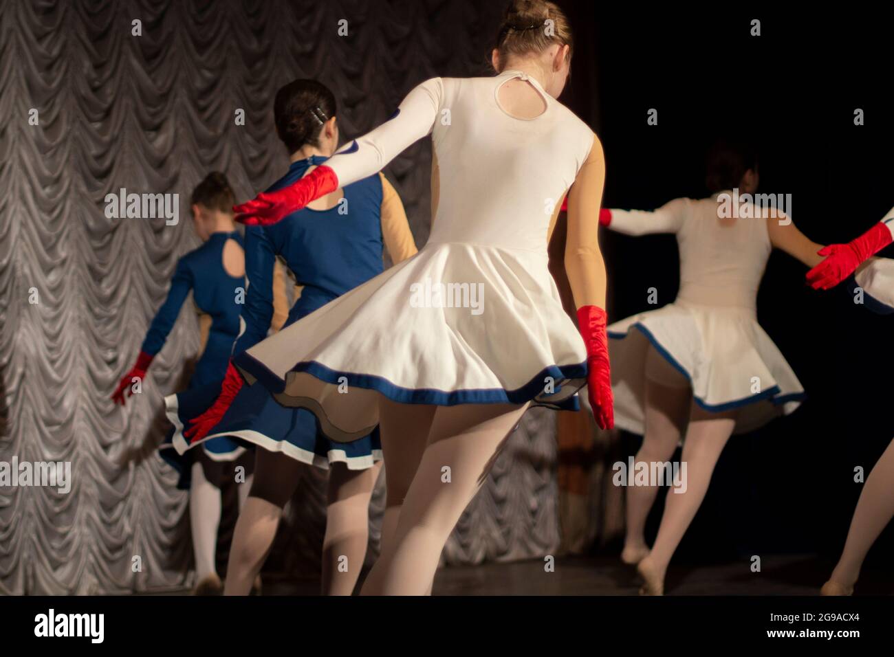 Children dance on stage. Dance lesson. Students learn to move ...