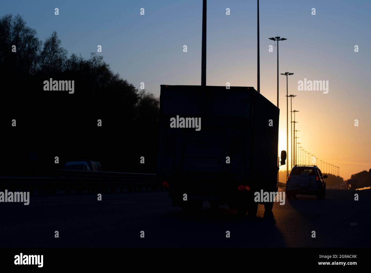 Sunset on the highway. The sun is setting over the highway. Loaded ...