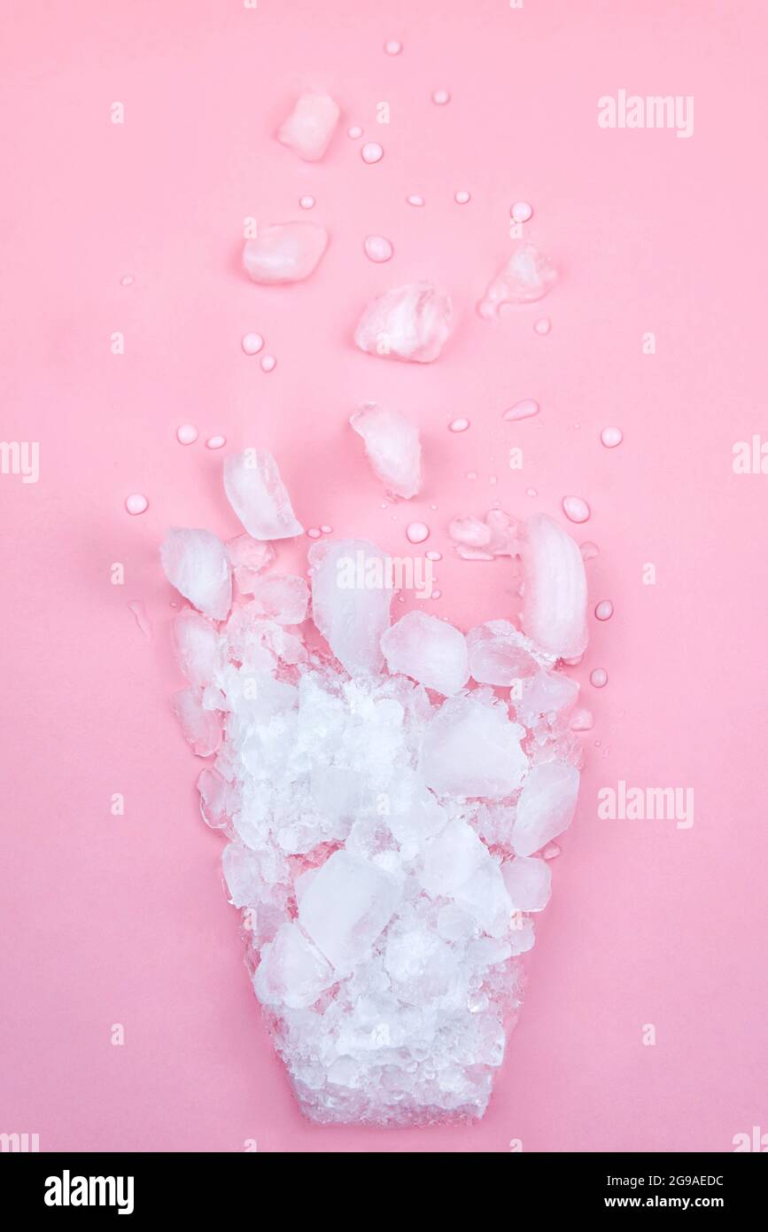 Ice laid out in the form of a glass on a pink background Stock Photo - Alamy