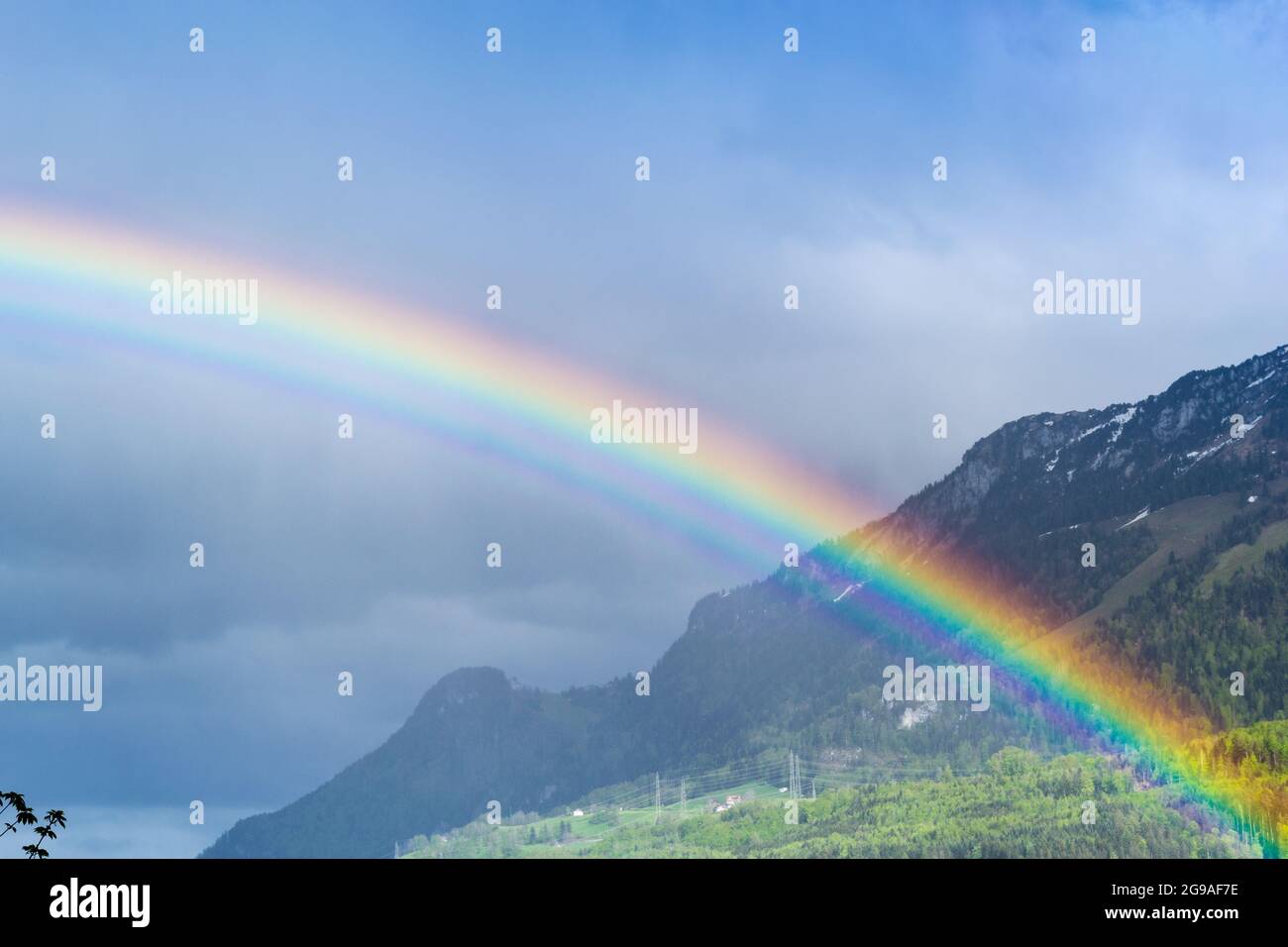 Rainbow in the sky over the mountains. Switzerland Stock Photo - Alamy