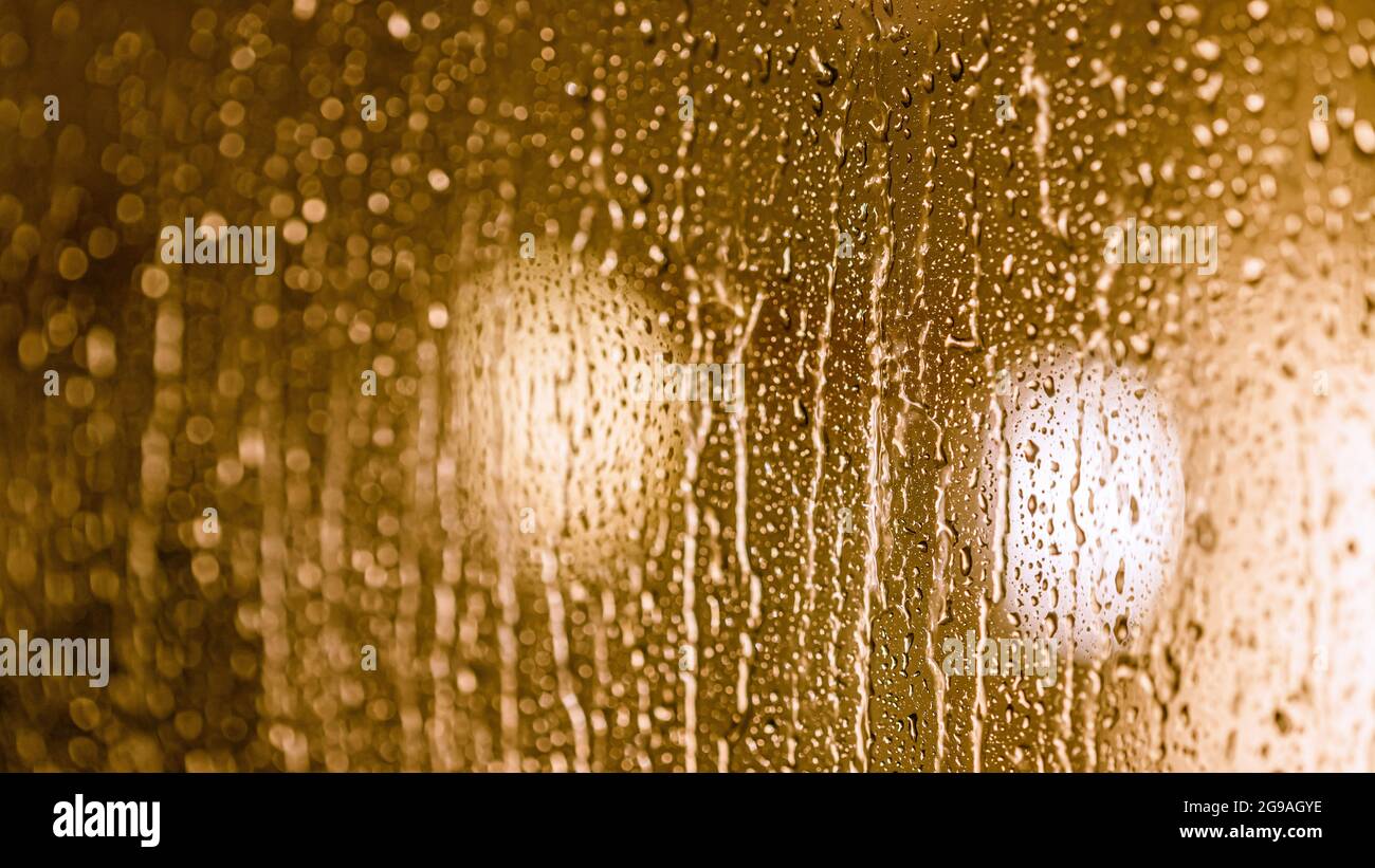 Close up of rain drops on the window in rainy night, warm lights Stock ...