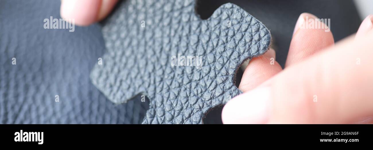 Female hand holding dark blue skin sample closeup Stock Photo - Alamy