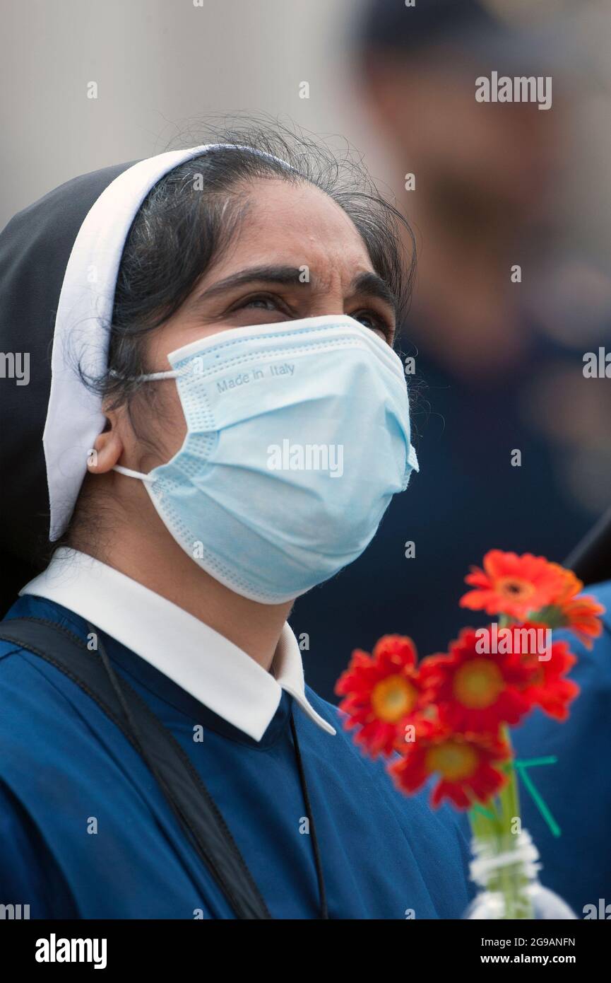 July 25, 2021. : Nun and Faithful hold a gerbera flower symbolic of ...