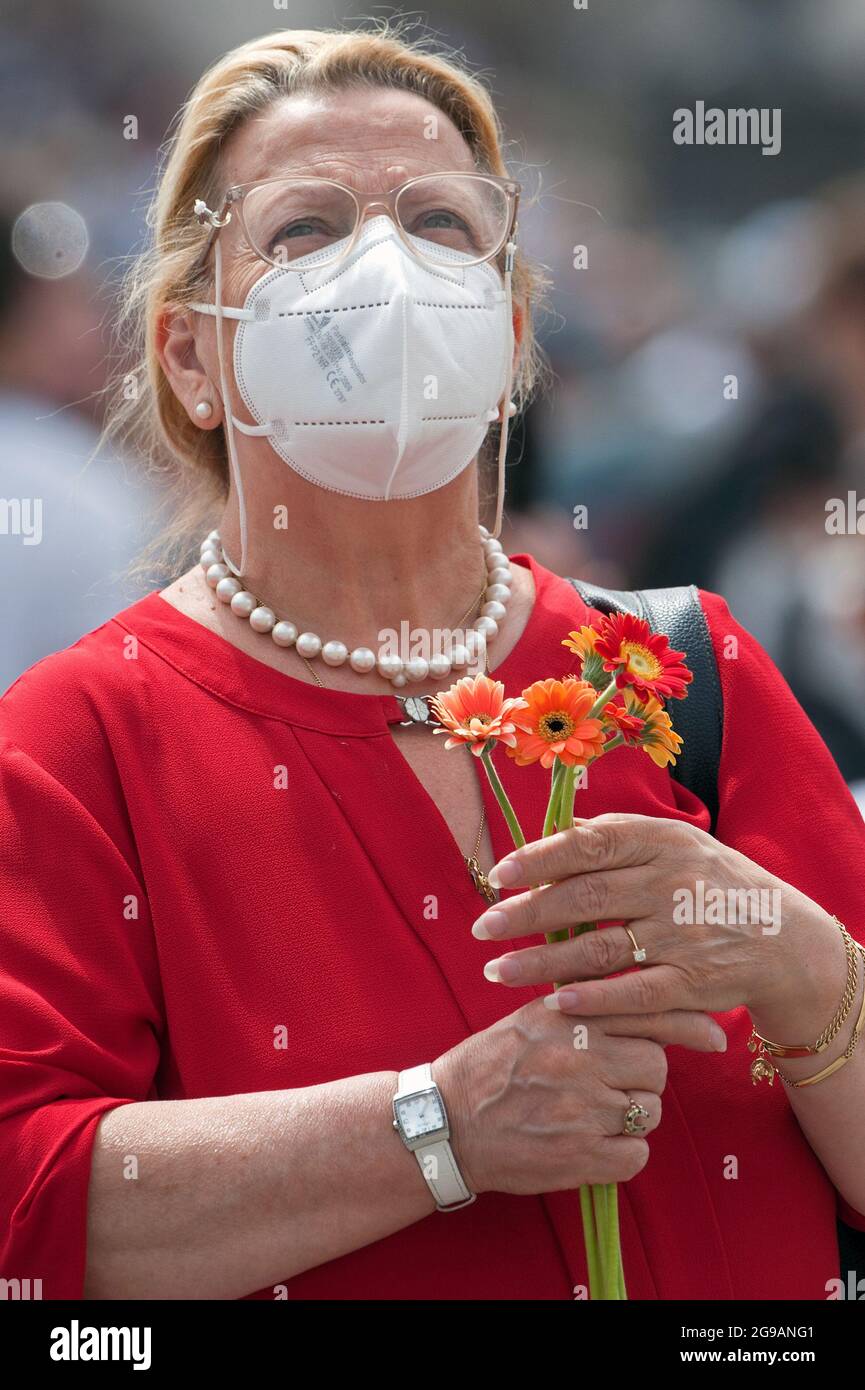 July 25, 2021. : Faithful elders hold a gerbera flower symbolic of ...