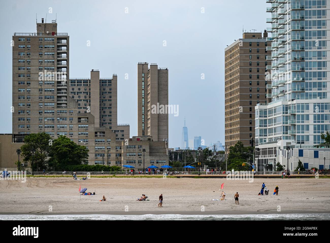 People enjoy the Coney Island beach in front of One World Trade Center ...