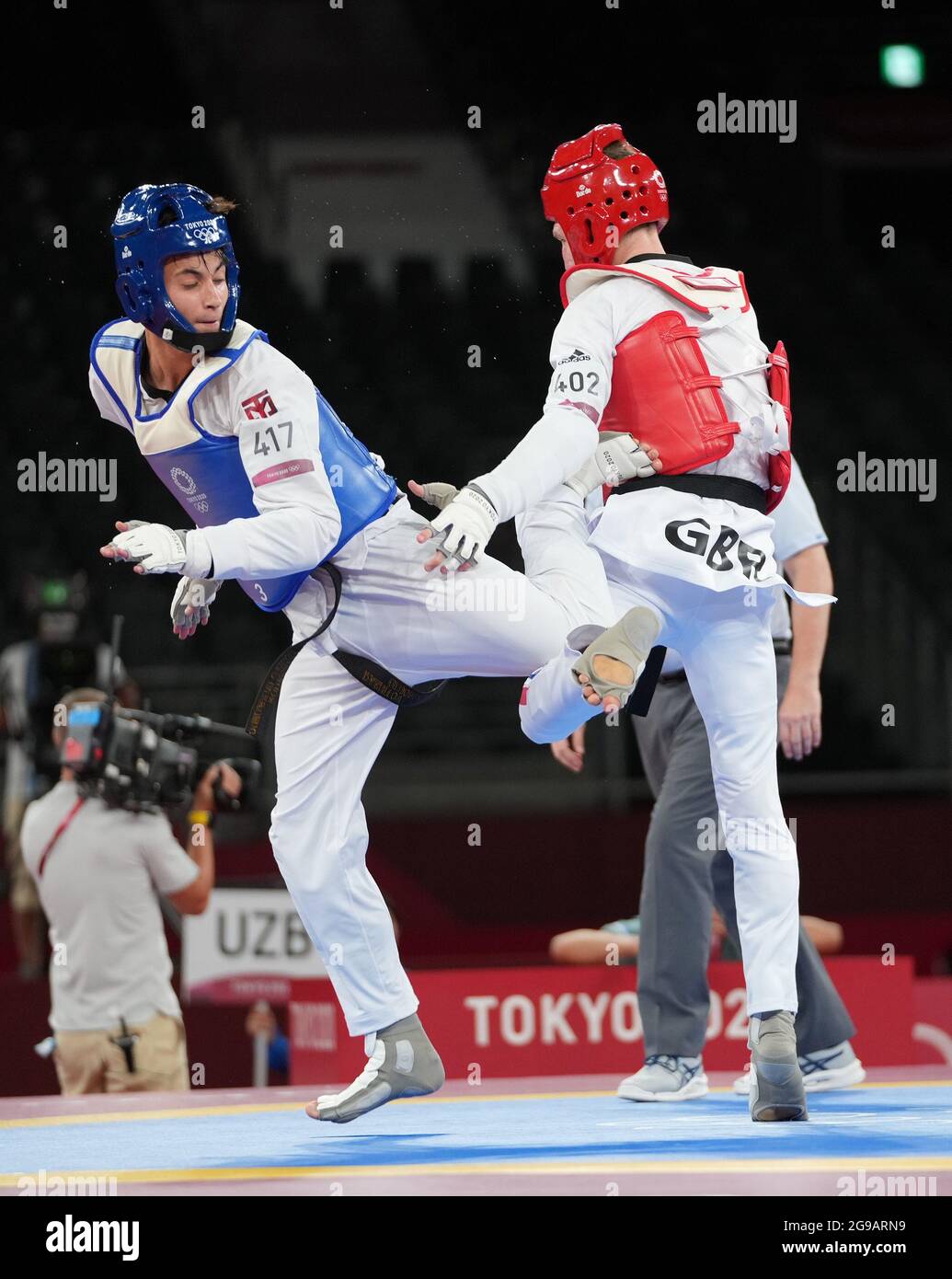 Tokyo, Japan. 25th July, 2021. Ulugbek Rashitov of Uzbekistan (L ...