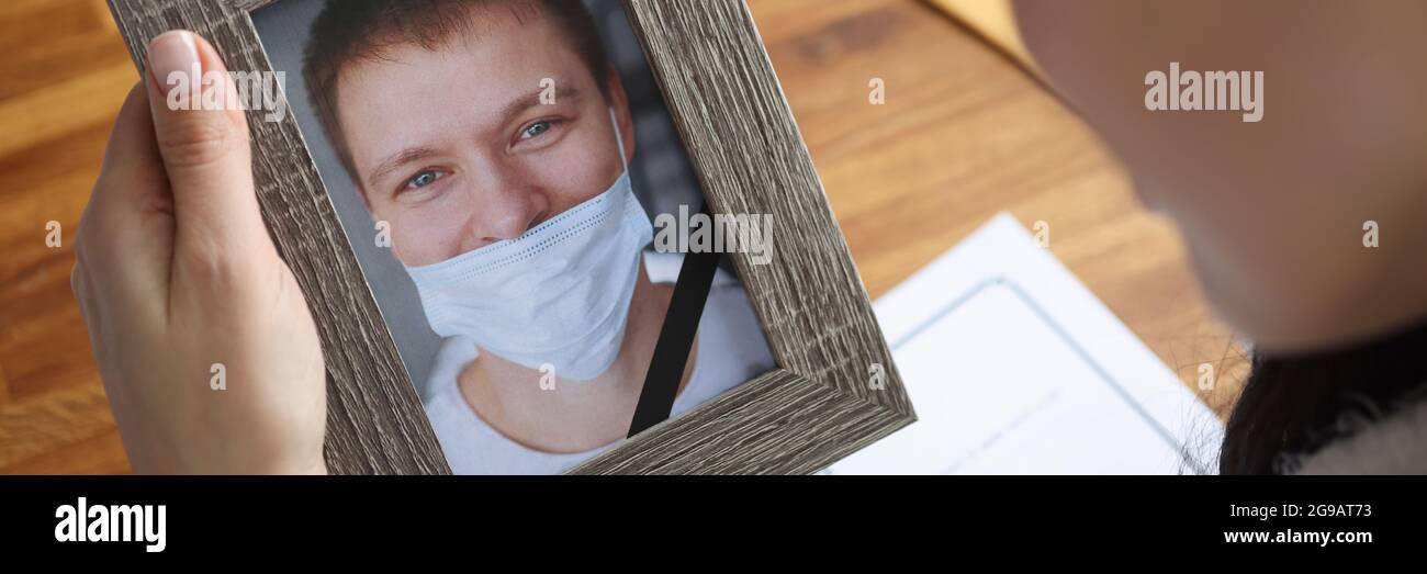 Woman crying over portrait of deceased young man closeup Stock Photo ... Woman crying over portrait of deceased young man closeup Stock Photo ...