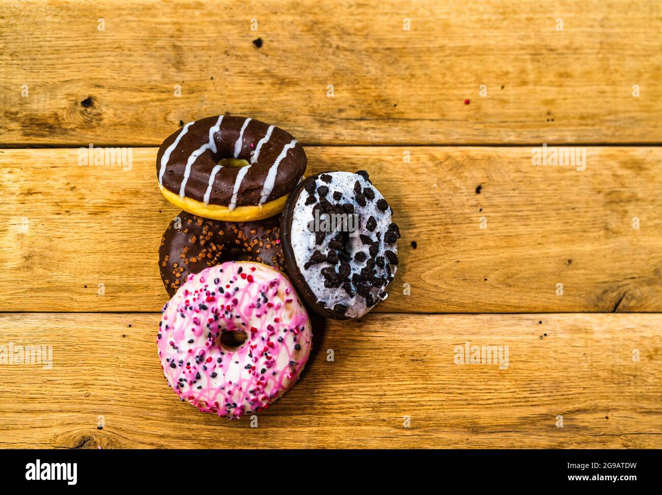 An overhead shot of colorful donuts with glazed sprinkles and chocolate ...
