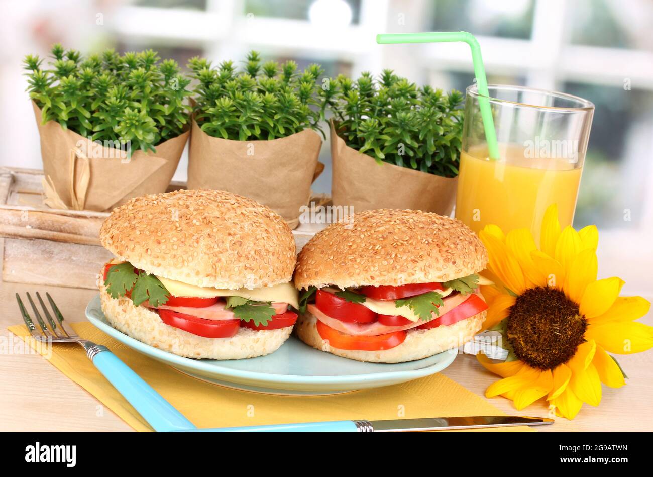 Appetizing sandwiches on color plate on wooden table on window ...