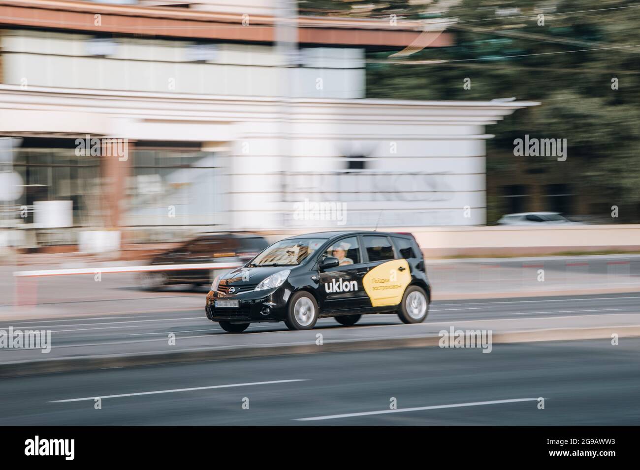 Ukraine, Kyiv - 16 July 2021: Black Nissan Note Taxi Uklon car moving ...