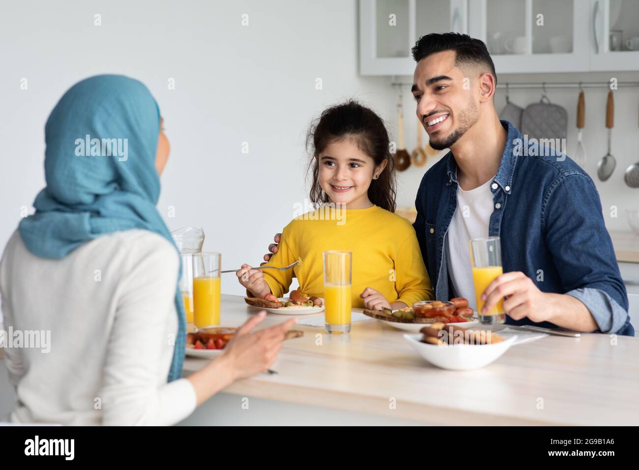 Lunch At Home. Young Muslim Family Of Three Eating Tasty Food In ...