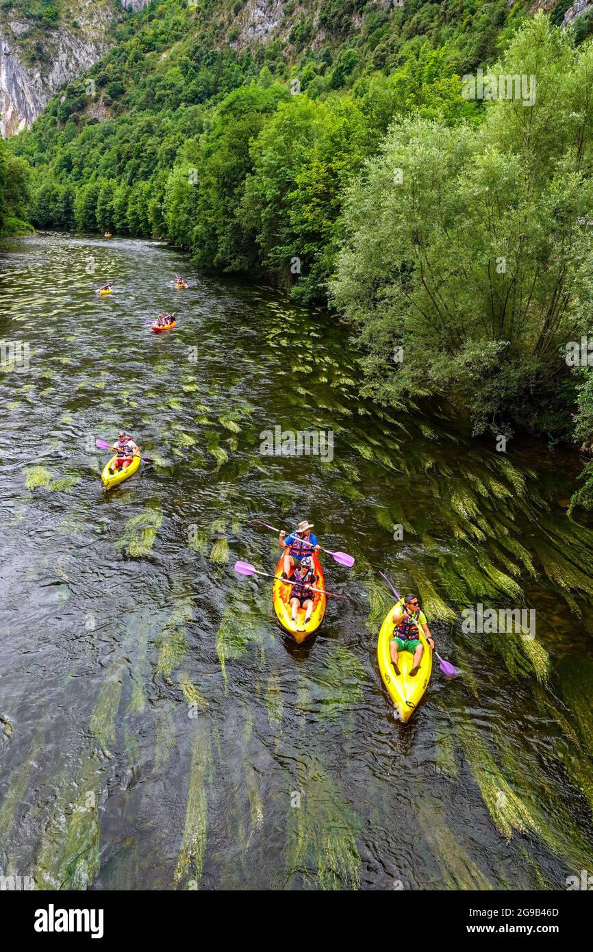 Canoeists canoeing down the Ariege River in the French Pyrenees, South ...