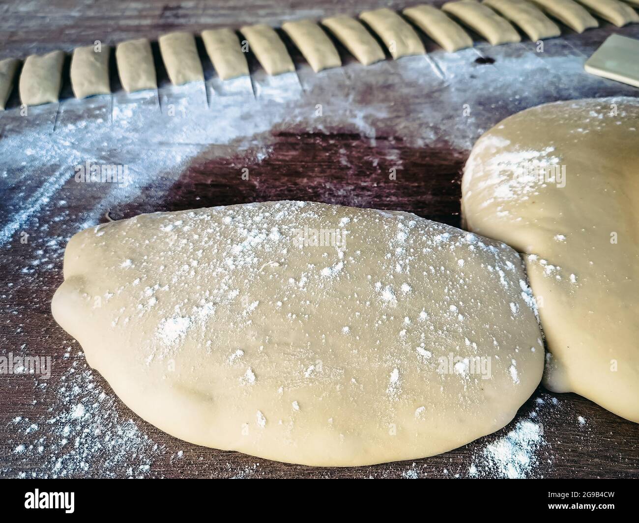 Wheat flour for making dough sticks or fried patongo on wooden board ...