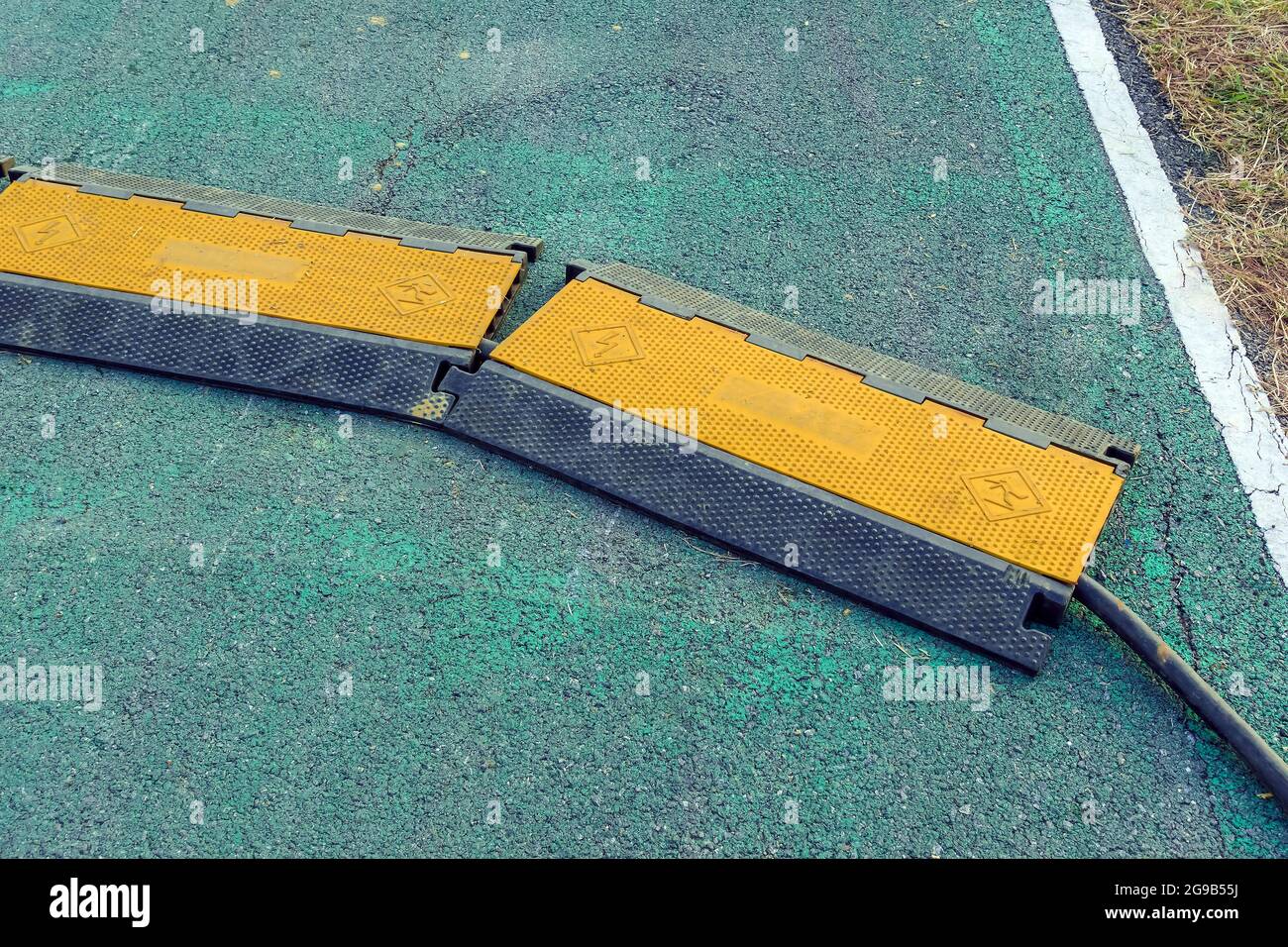 Black and yellow heavy plastic covers for people and vehicle to cross ...