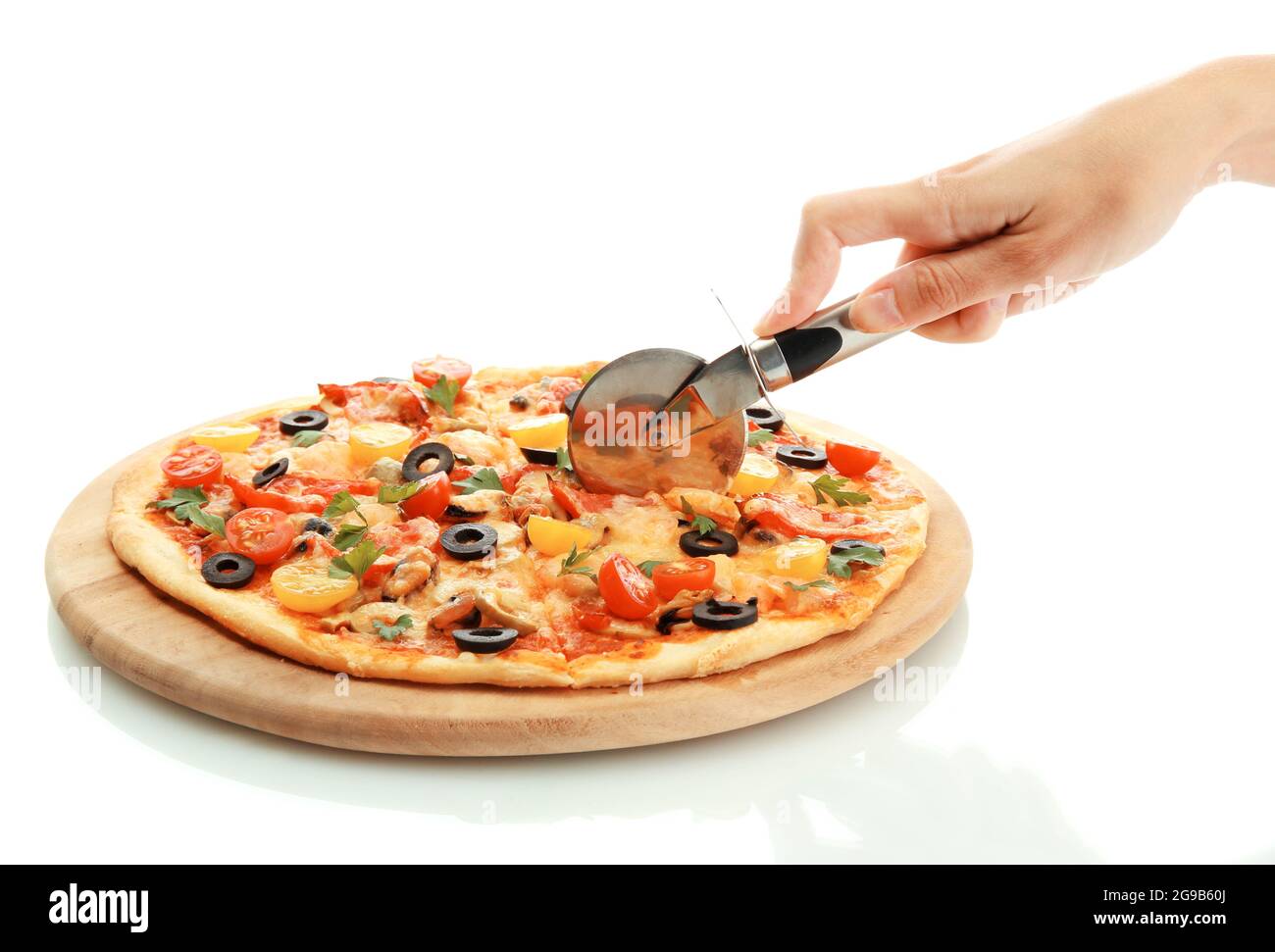 woman's hand with a knife cut the pizza on white background close-up ...