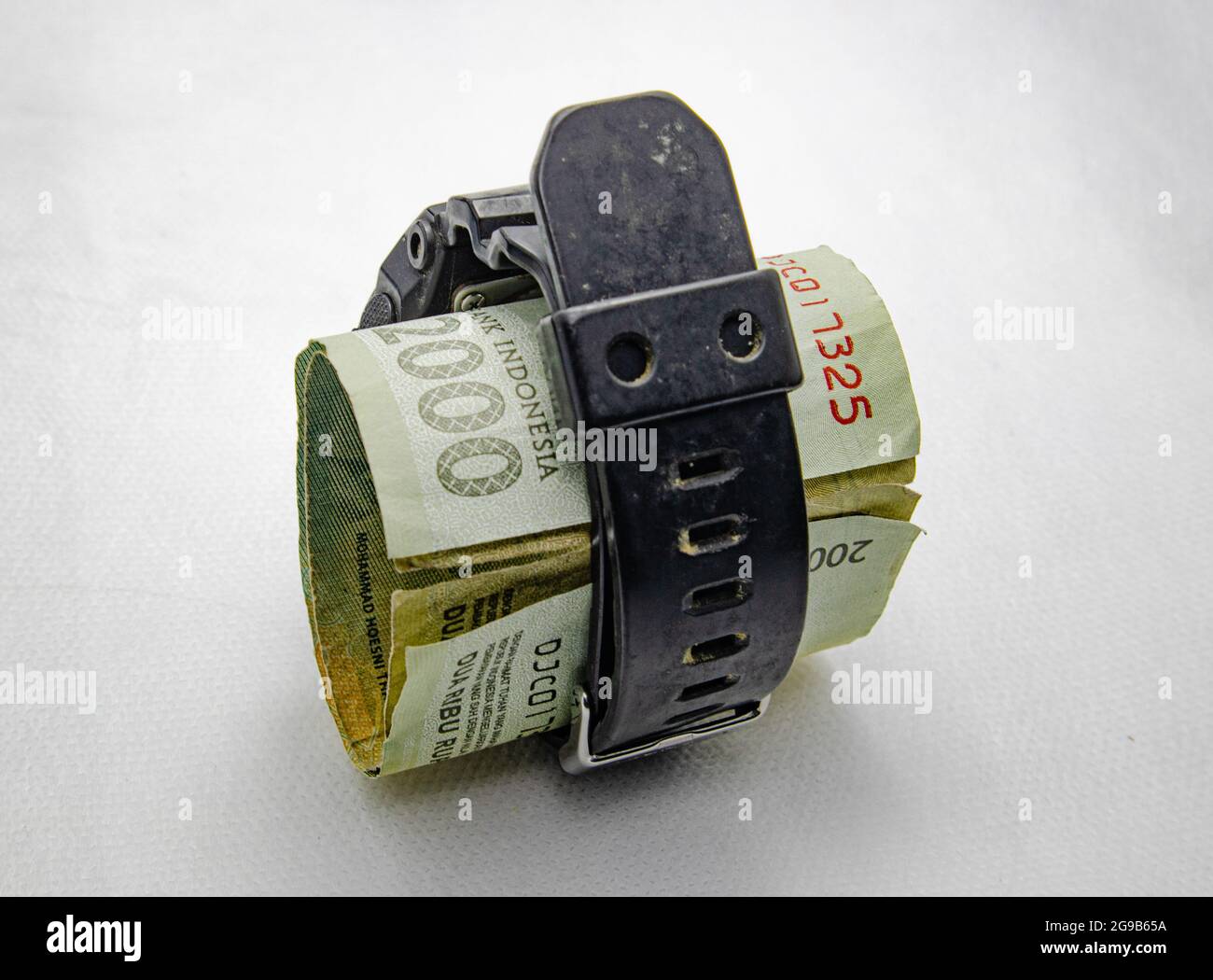 Watches and rolls of money Stock Photo - Alamy