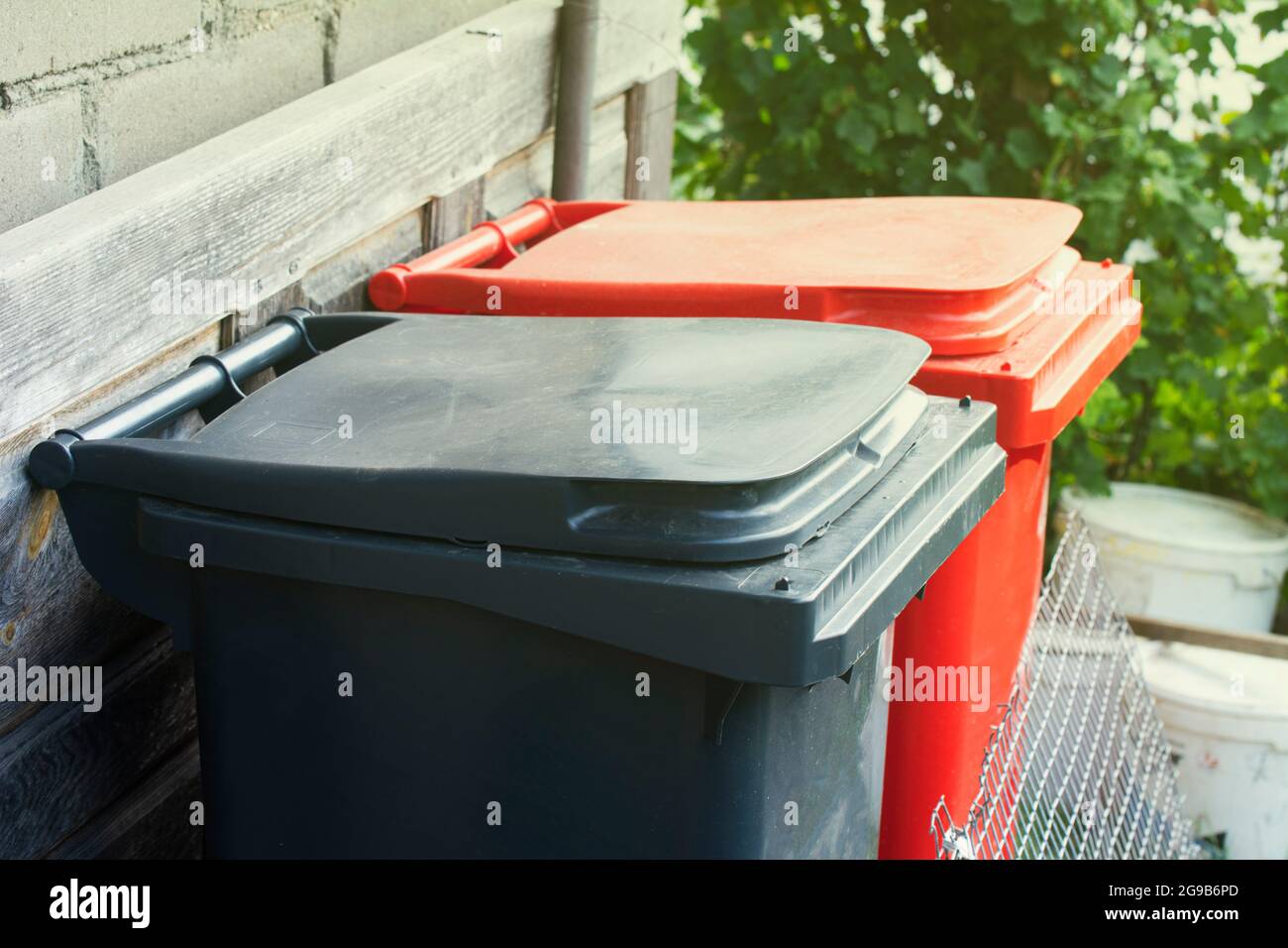 Two recycling garbage containers red and gray color. Colorful recycle ...