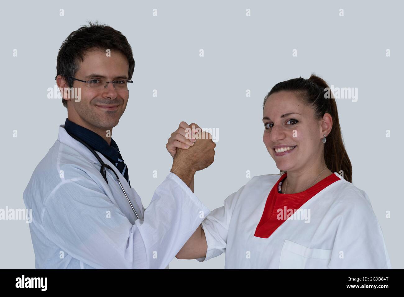 Doctor and nurse hug each other smiling at camera. Collaboration ...