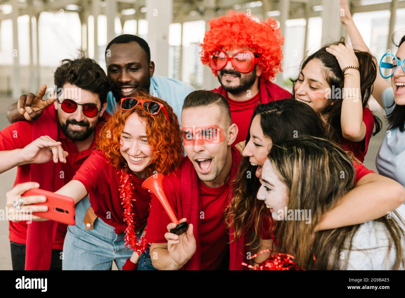 Happy multiracial group of football fans taking selfie out of the ...