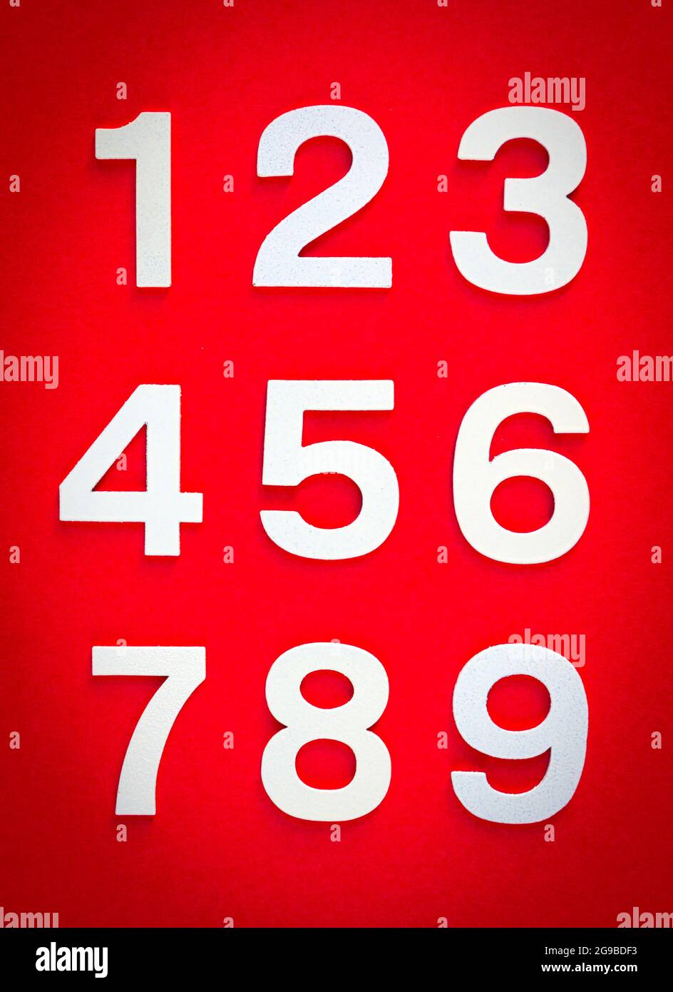 Mathematics background made with solid numbers from 1 to 9 on a red ...