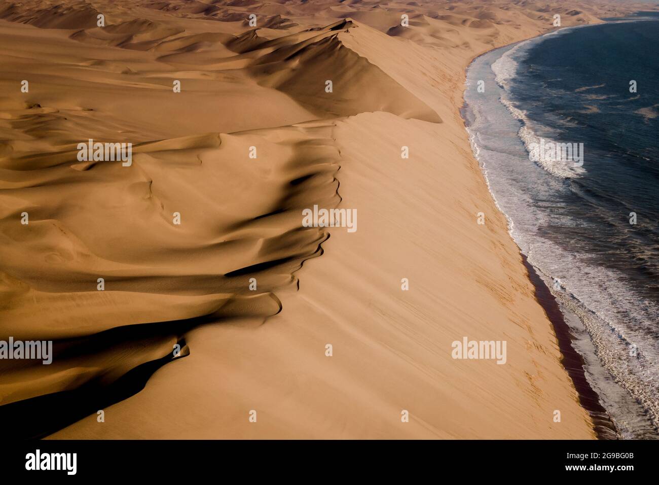 Aerial view of Sandwich Harbour, where the Namib desert meets the Atlantic coast, near Walvis ...