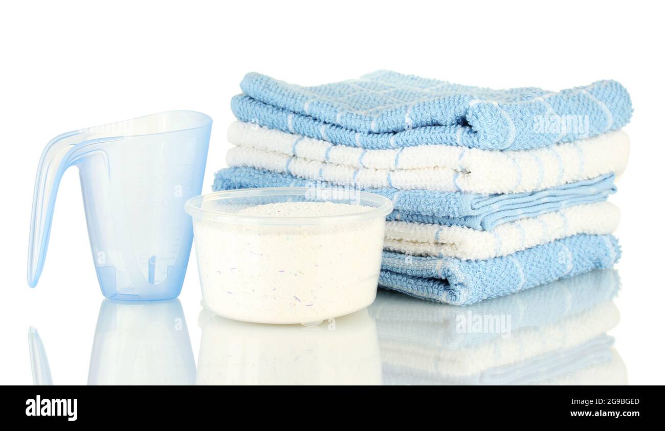 measuring cups with washing powder and towels, isolated on white Stock ...