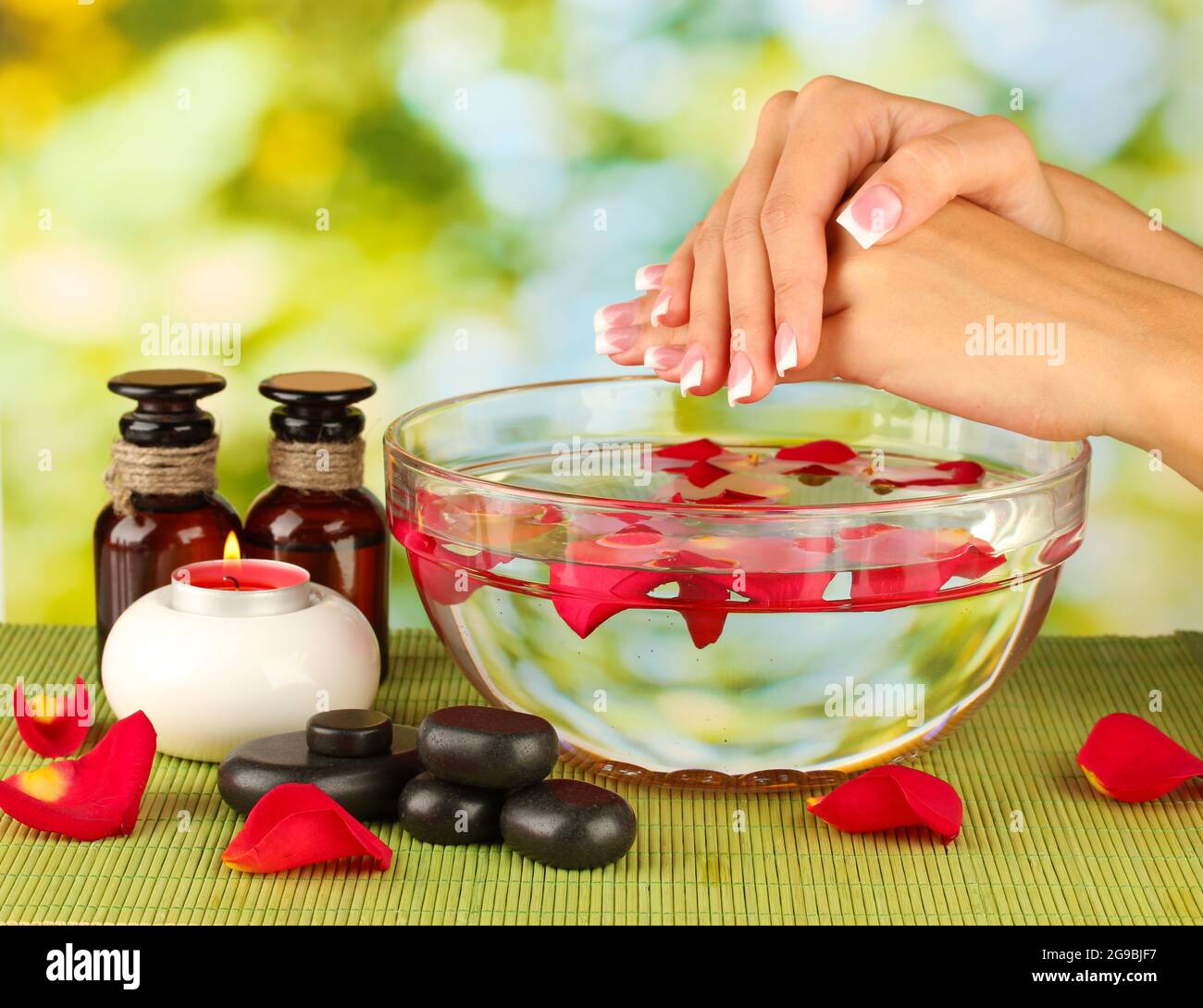 spa treatments for female hands, on green background Stock Photo - Alamy