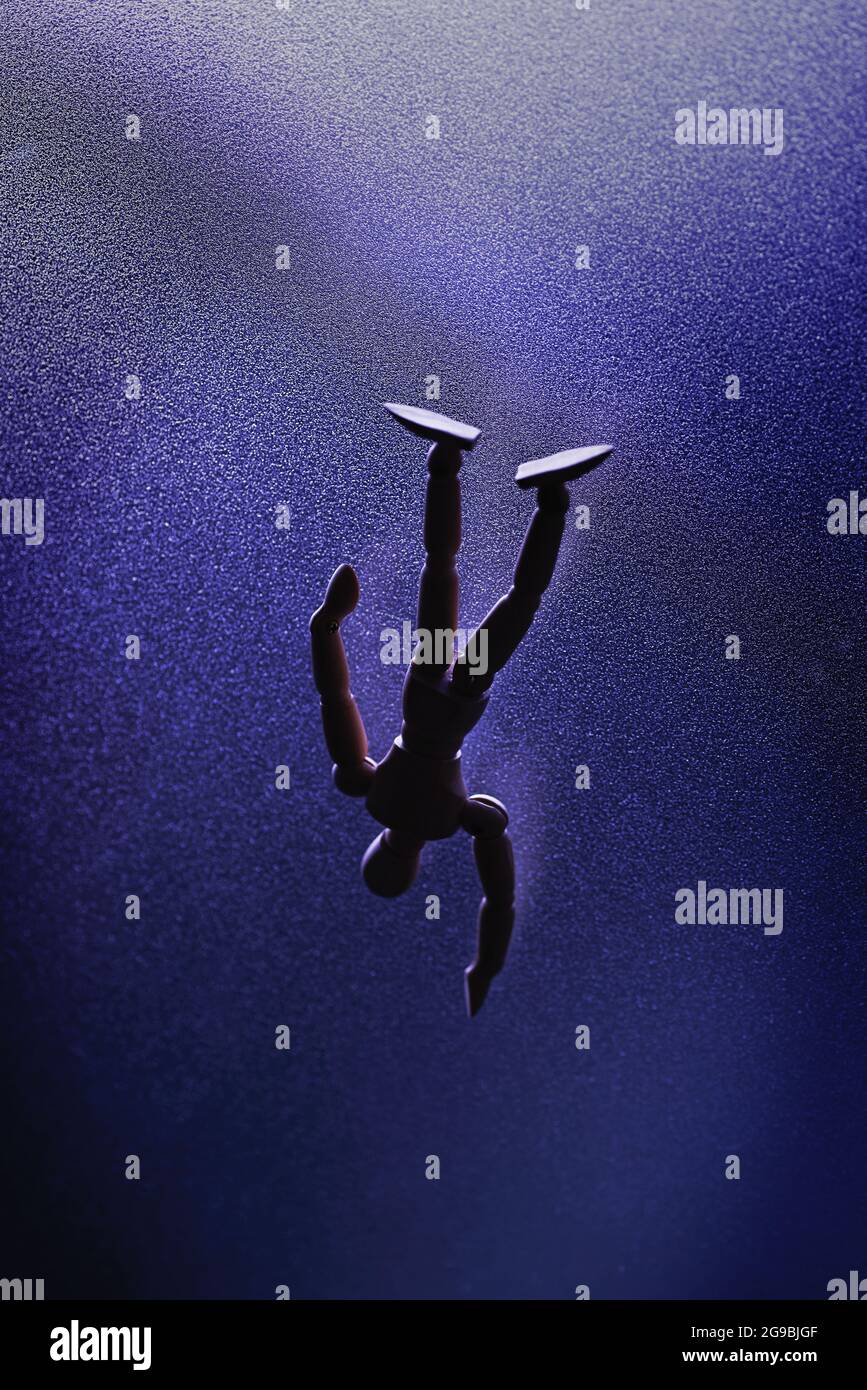 A small wooden artists model in a falling position Stock Photo - Alamy