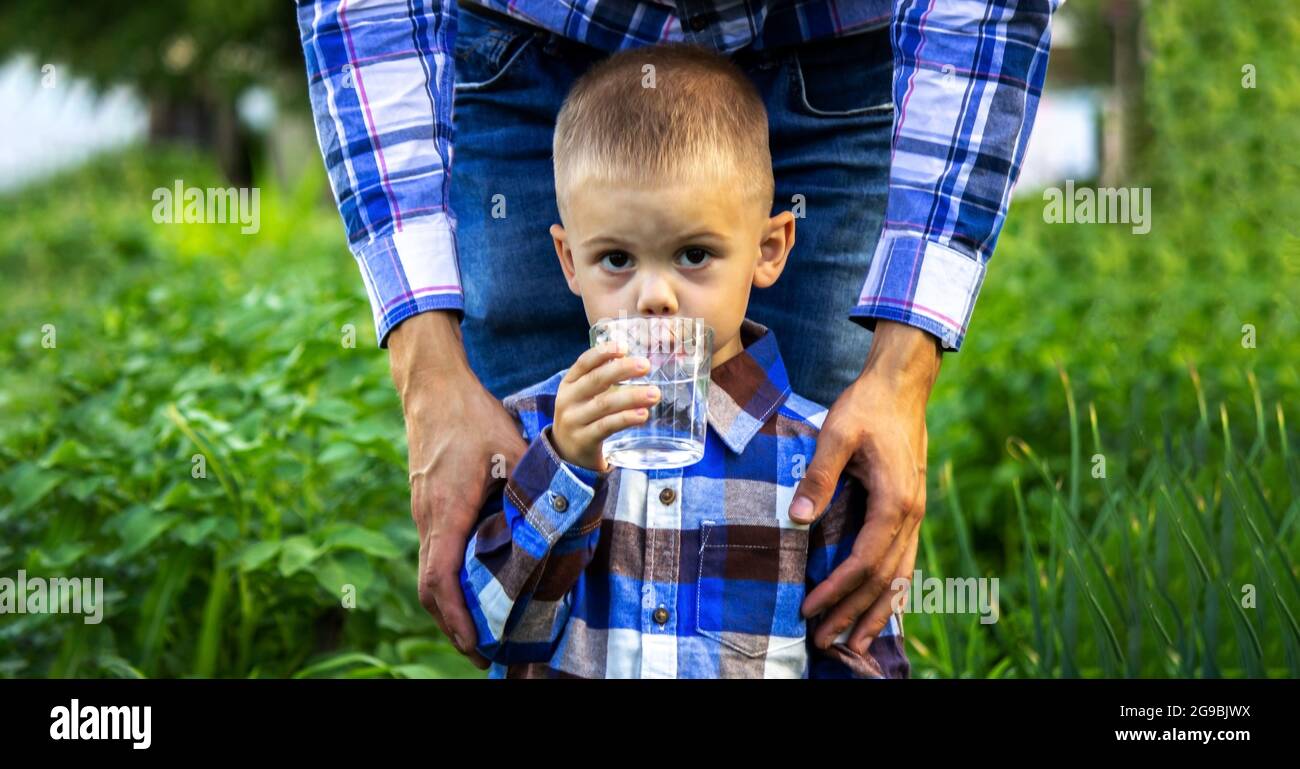 The child drinks clean water in nature. Selective focus Stock Photo - Alamy