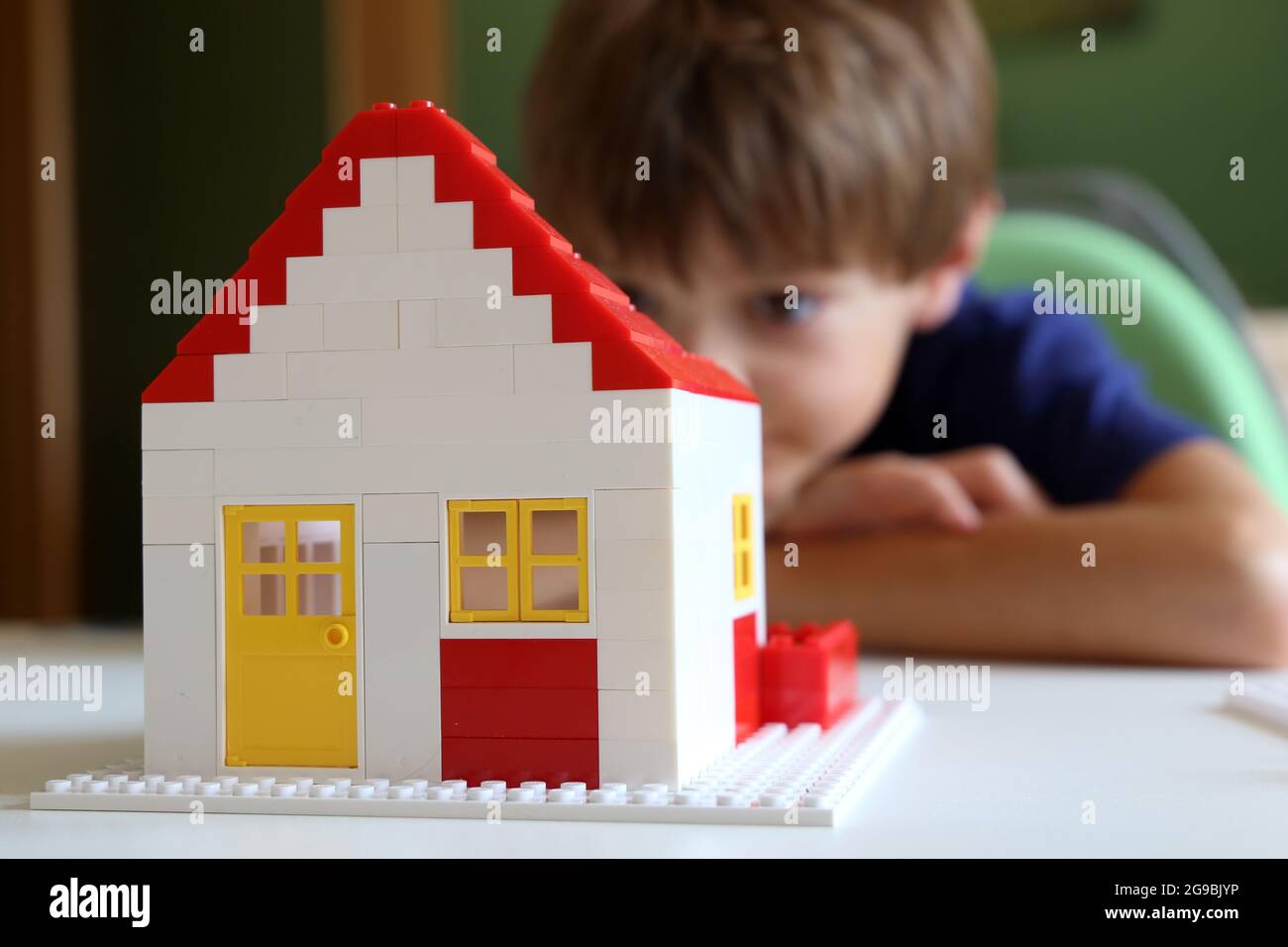 Symbol image: Boy builds a house with building blocks (Model released ...