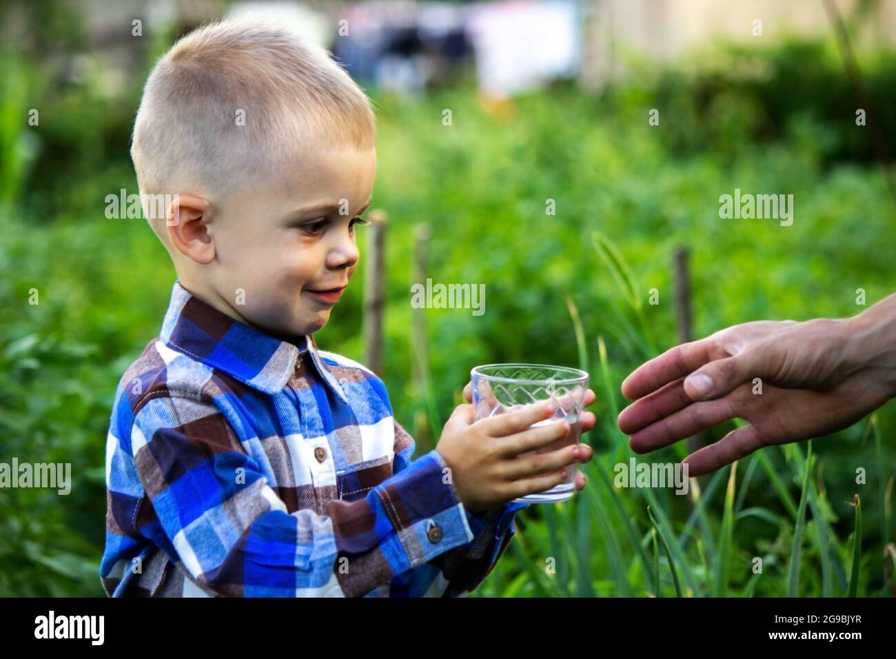 The child drinks clean water in nature. Selective focus Stock Photo - Alamy