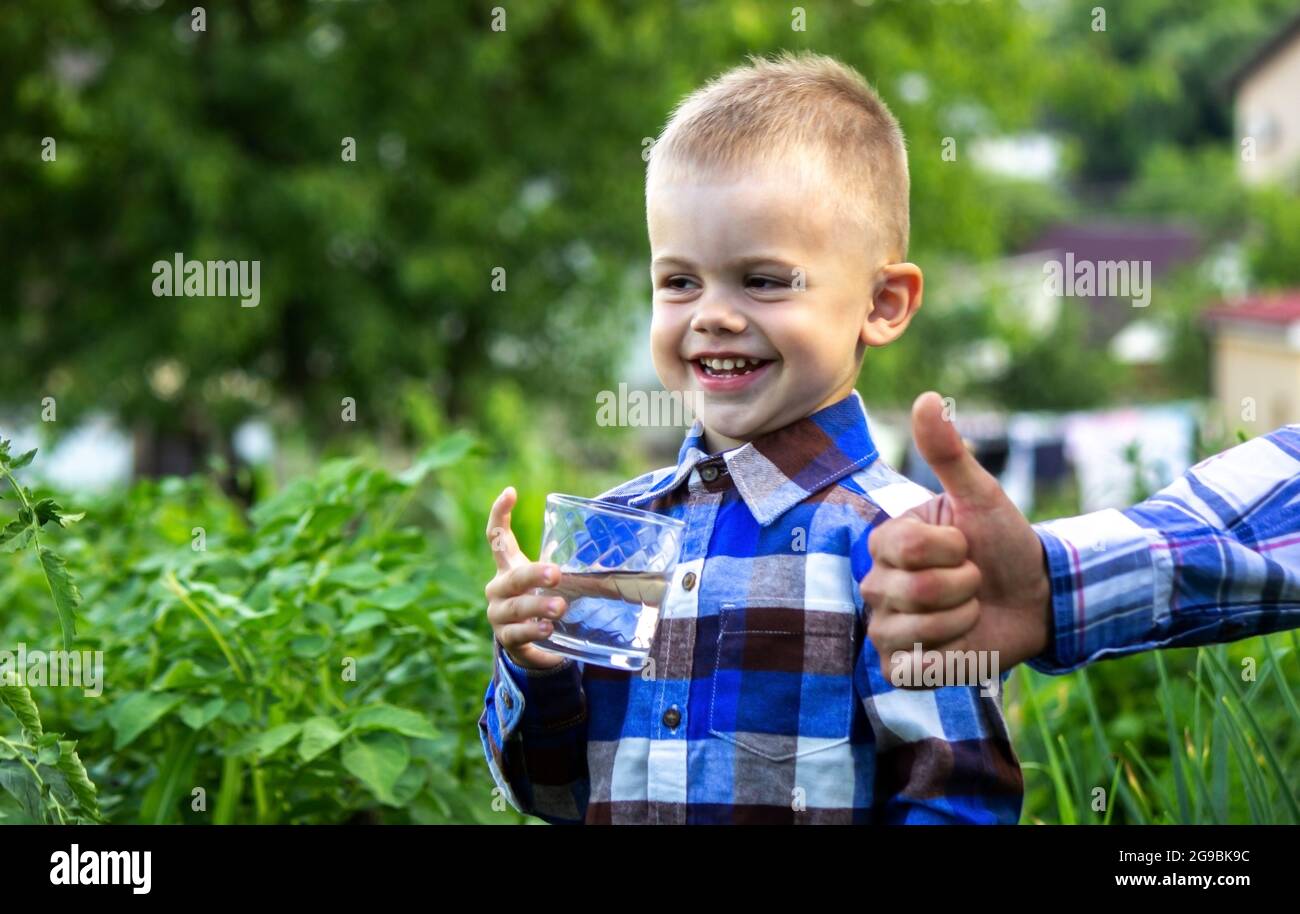 The child drinks clean water in nature. Selective focus Stock Photo - Alamy