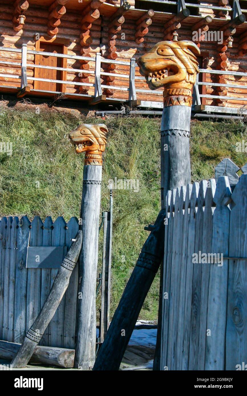 Gate in the architectural historical park. Totem gate posts with carved ...