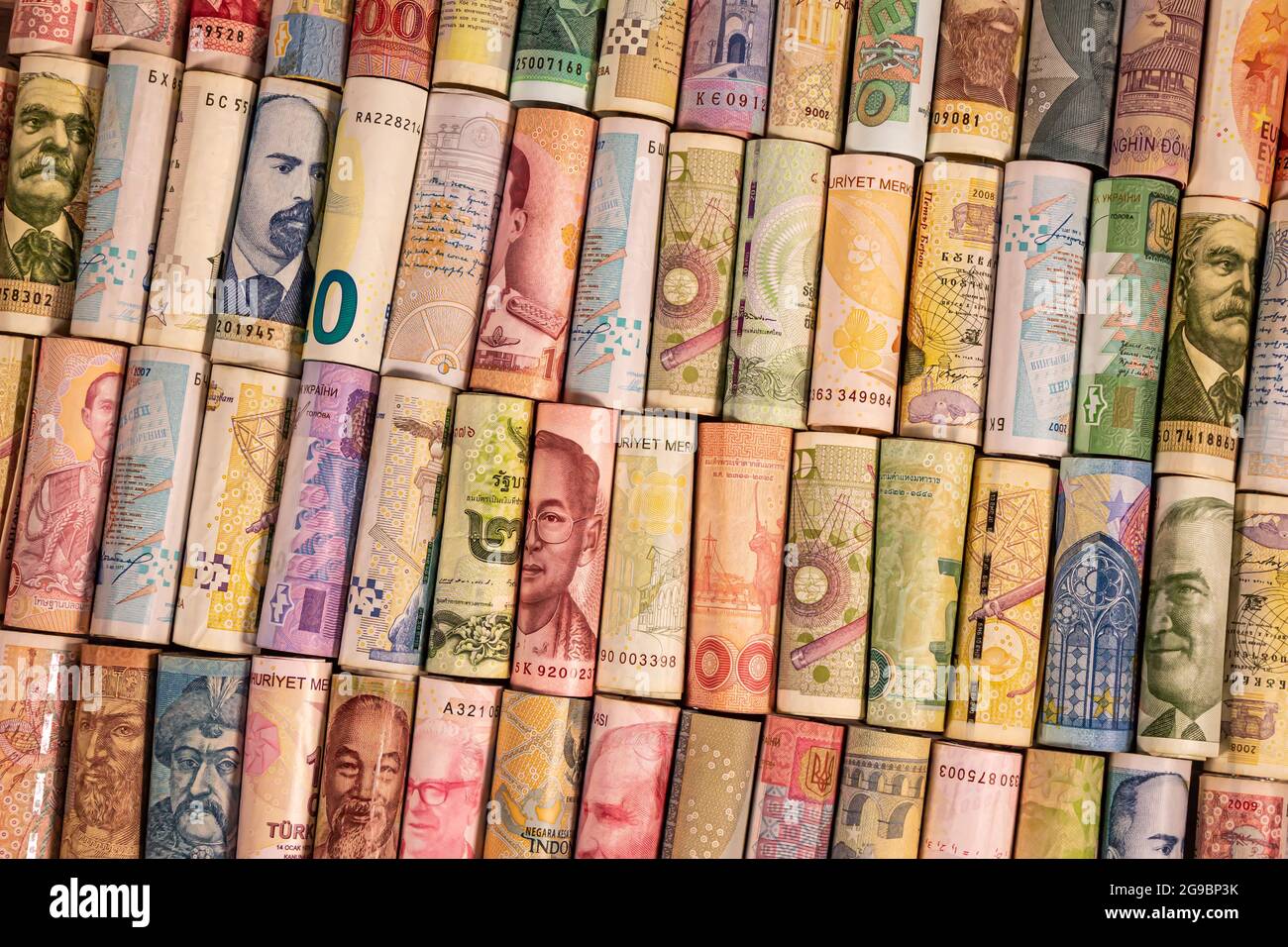 Different colourful banknotes from various countries on rolls to be ...