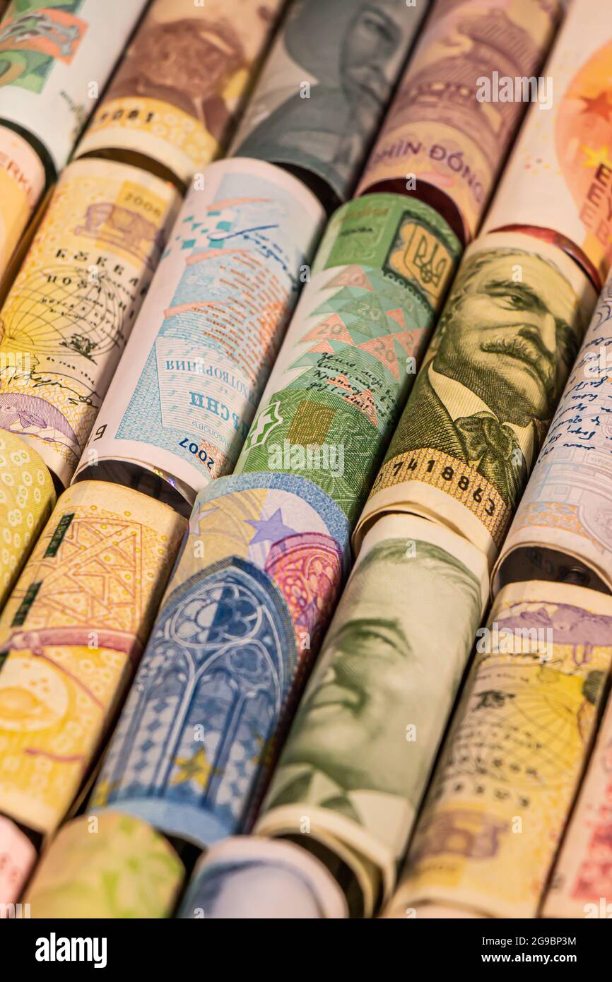 Different colourful banknotes from various countries on rolls to be ...