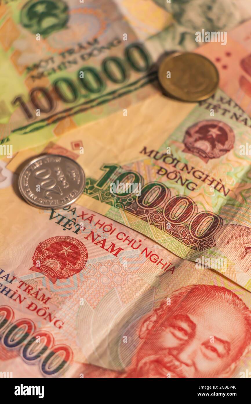 A composition of Vietnamese dong VND banknotes and coins providing ...