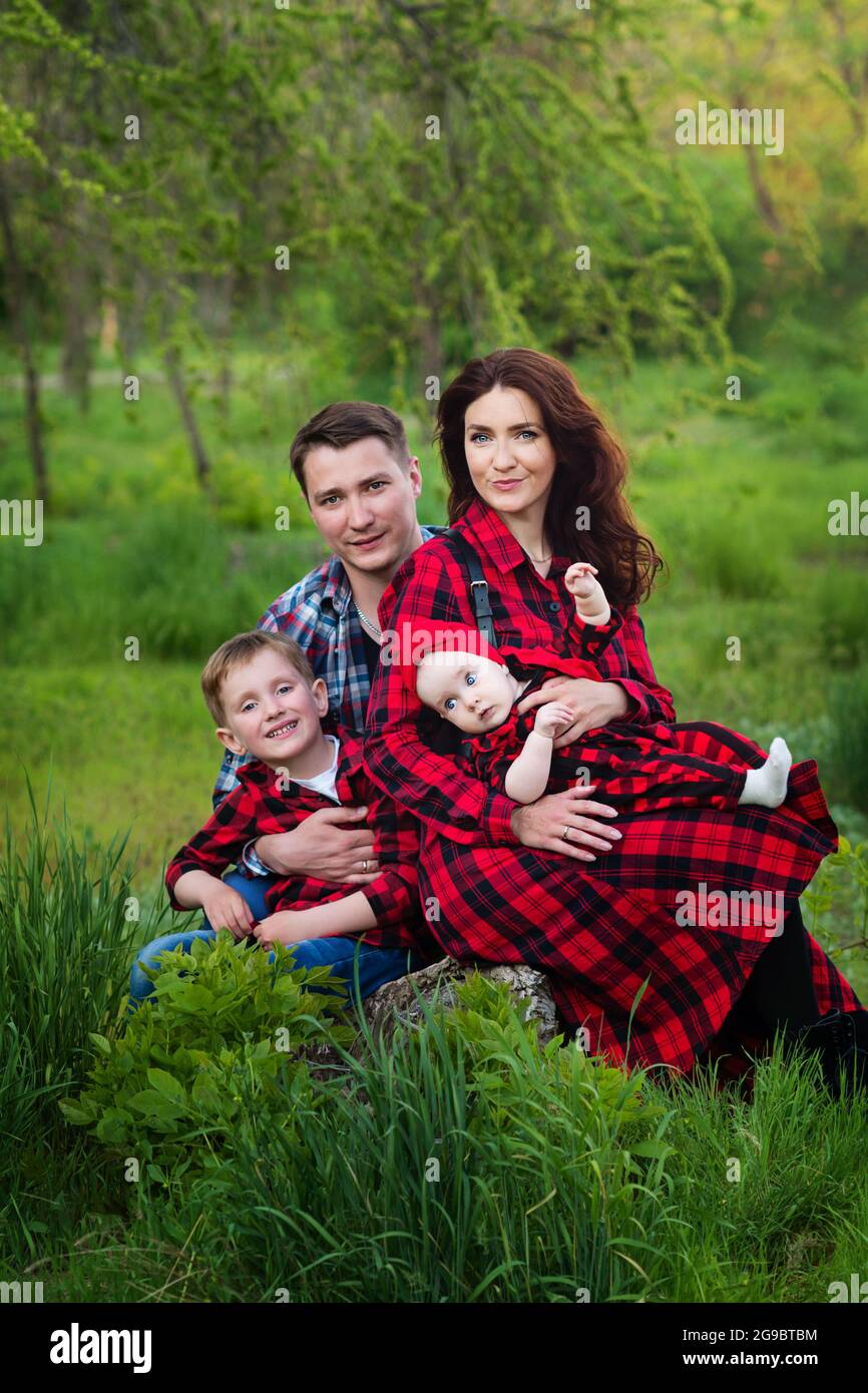 Happy family spend time together outside in green nature. International ...