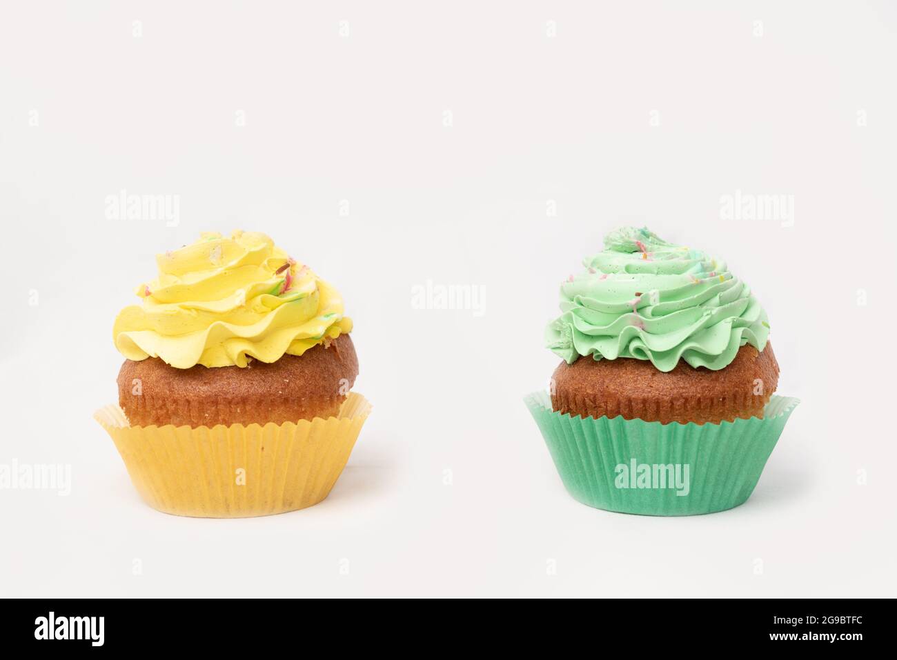 yellow and green Cupcake on white background Stock Photo - Alamy