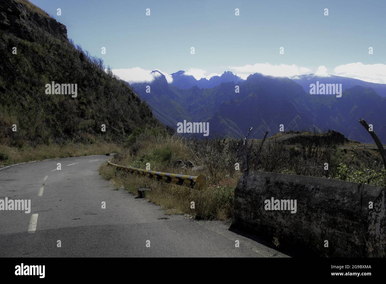 An empty winding highway on the side of a mountain slope Stock Photo ...