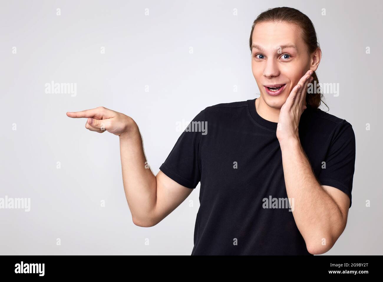 Surprised man pointing fingers show hi-res stock photography and images ...
