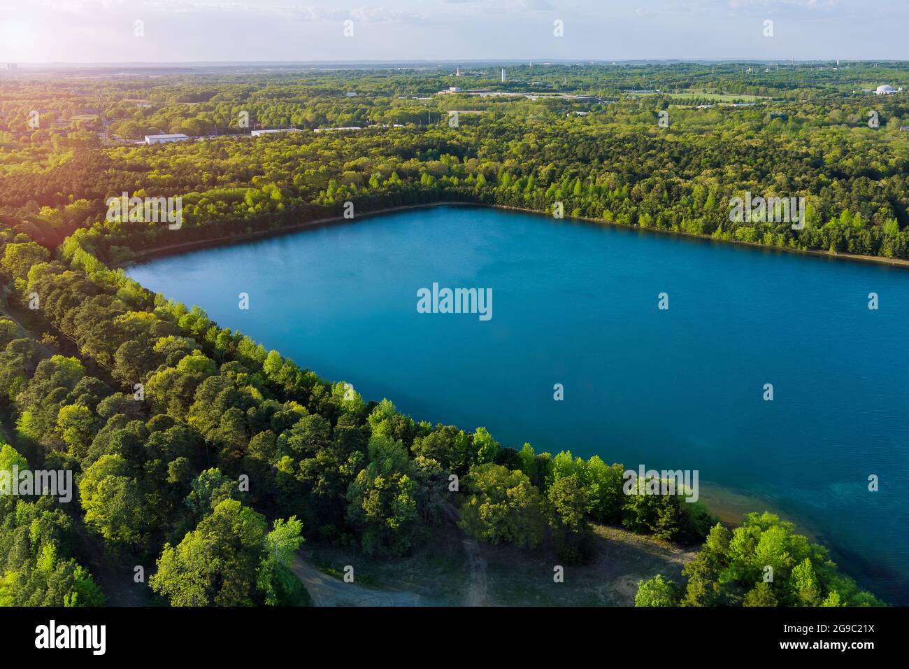 Aerial panorama view on the green forest between turquoise color lake ...