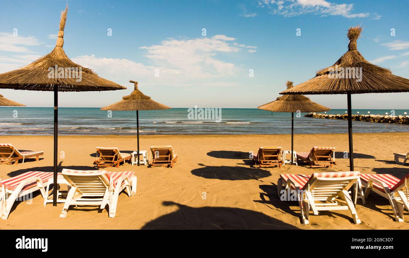 straw umbrellas on the sandy beach Stock Photo - Alamy