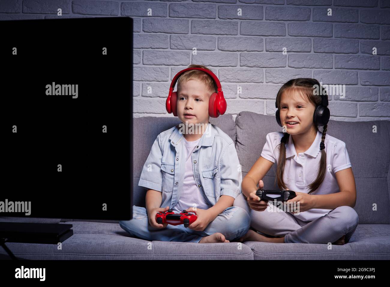 children playing video game with game console Stock Photo - Alamy
