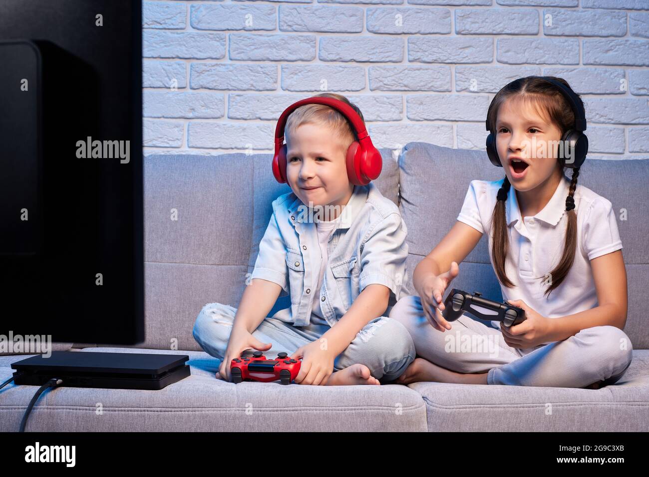 children playing video game with game console Stock Photo - Alamy