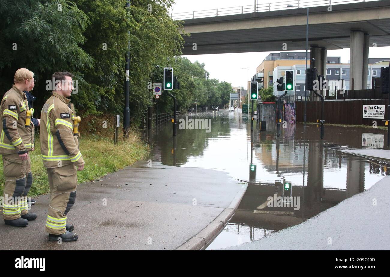 Firefighters look along Chigwell Road in south Woodford. The A406 ...