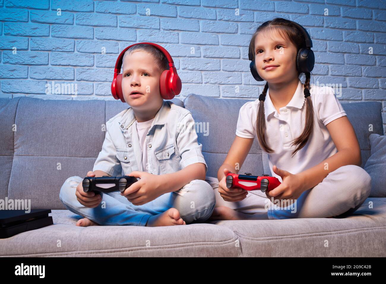 children playing video game with game console Stock Photo - Alamy