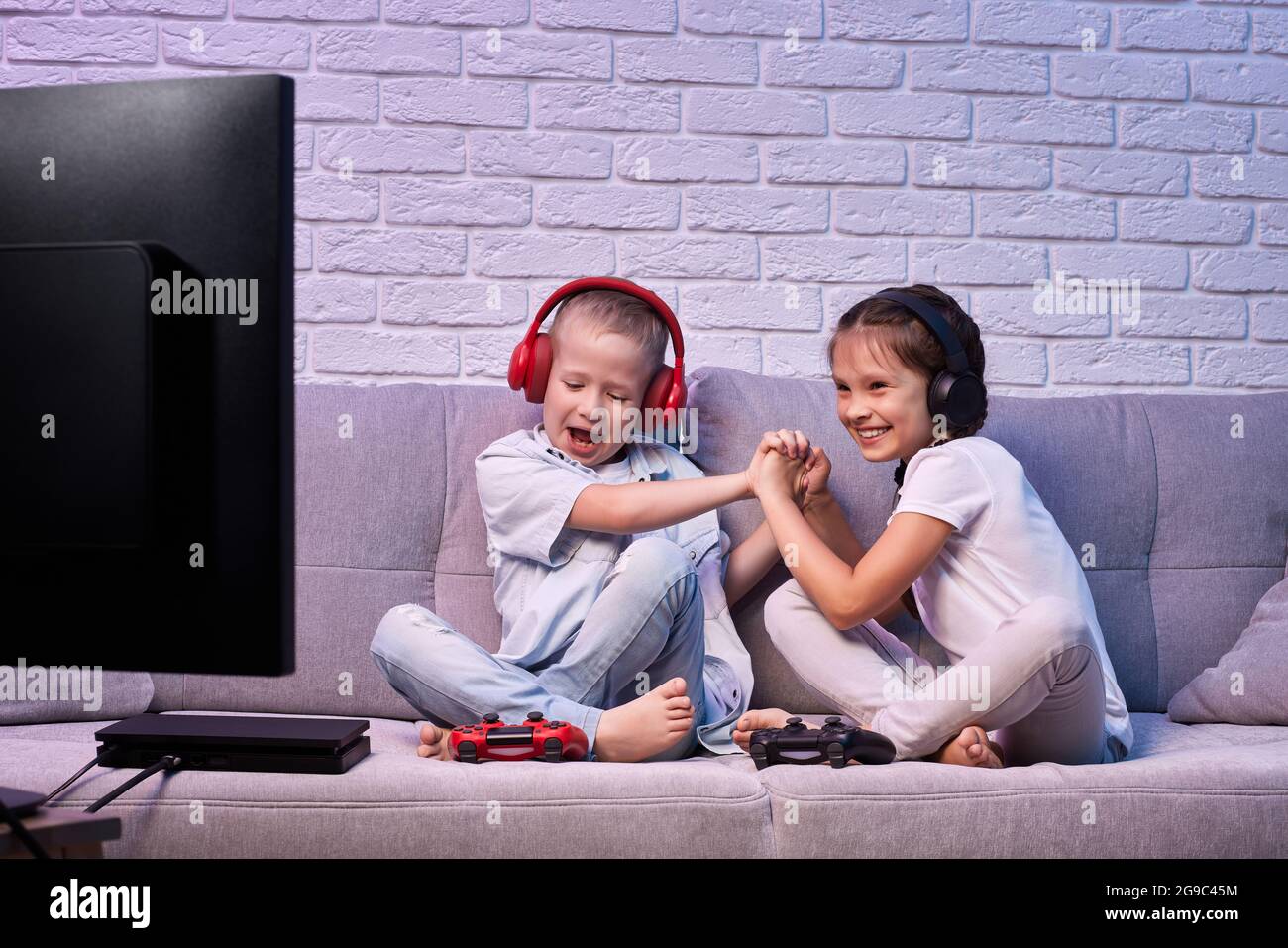 children playing video game with game console Stock Photo - Alamy
