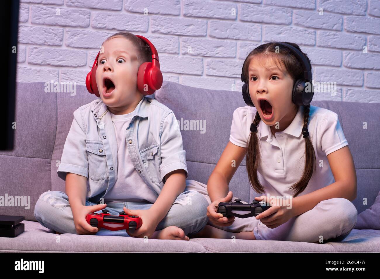 children playing video game with game console Stock Photo - Alamy